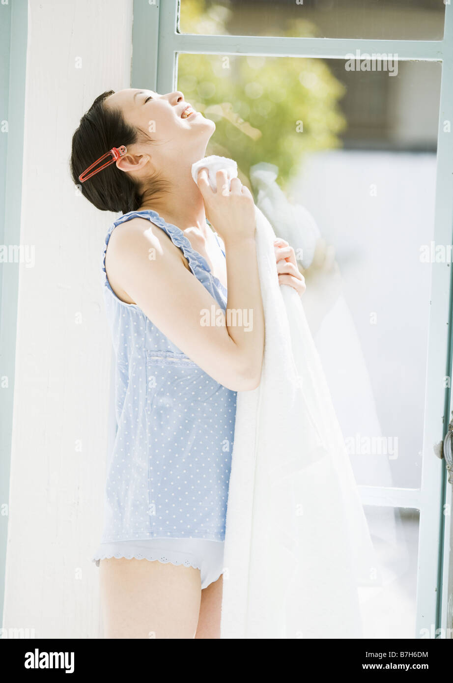 Woman Standing by the Window Stock Photo - Alamy