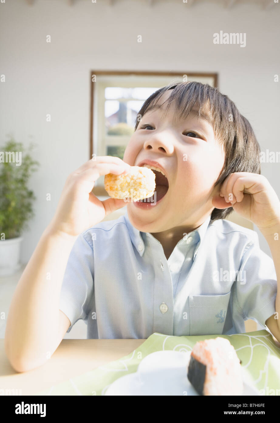 Boy eating rice ball hi-res stock photography and images - Alamy