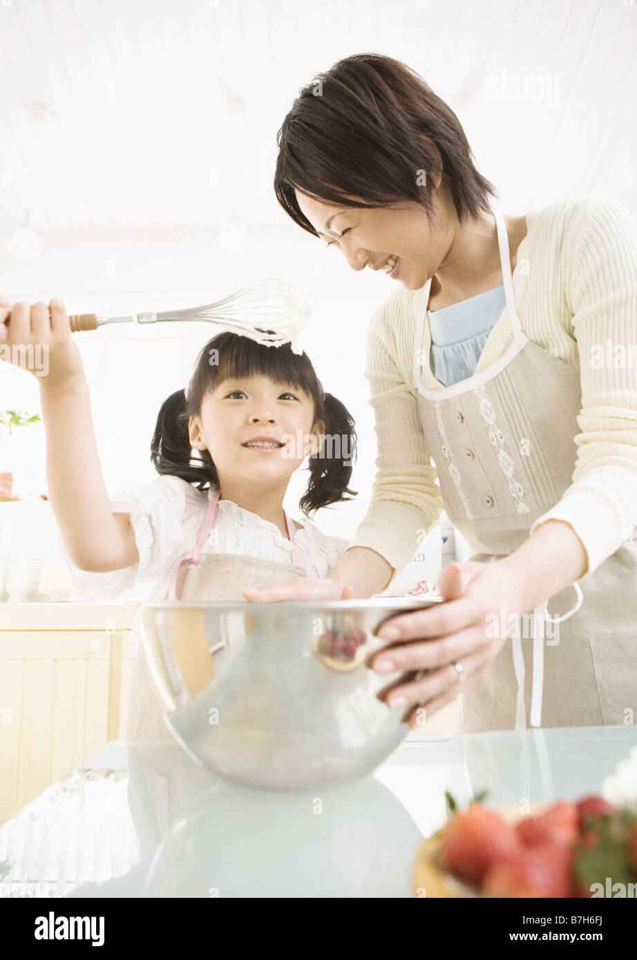 Mother and Daughter Making a Cake Stock Photo - Alamy