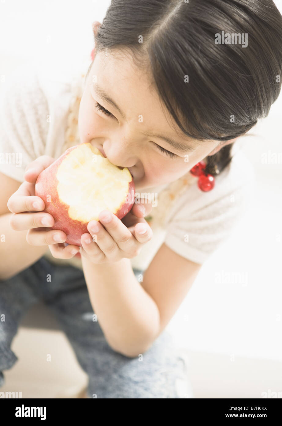 Girl Eating an Apple Stock Photo - Alamy