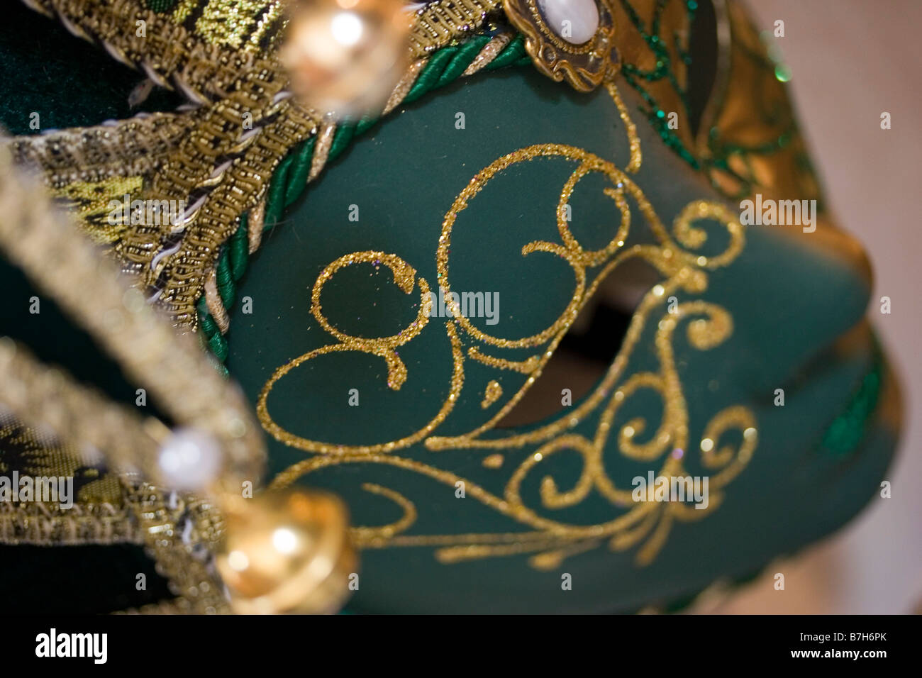 A traditional carnival mask in green with gold colored trim in Venice ...