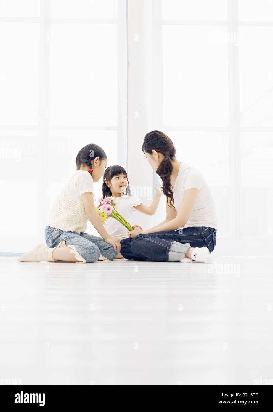 Three children talking to each other hi-res stock photography and ...