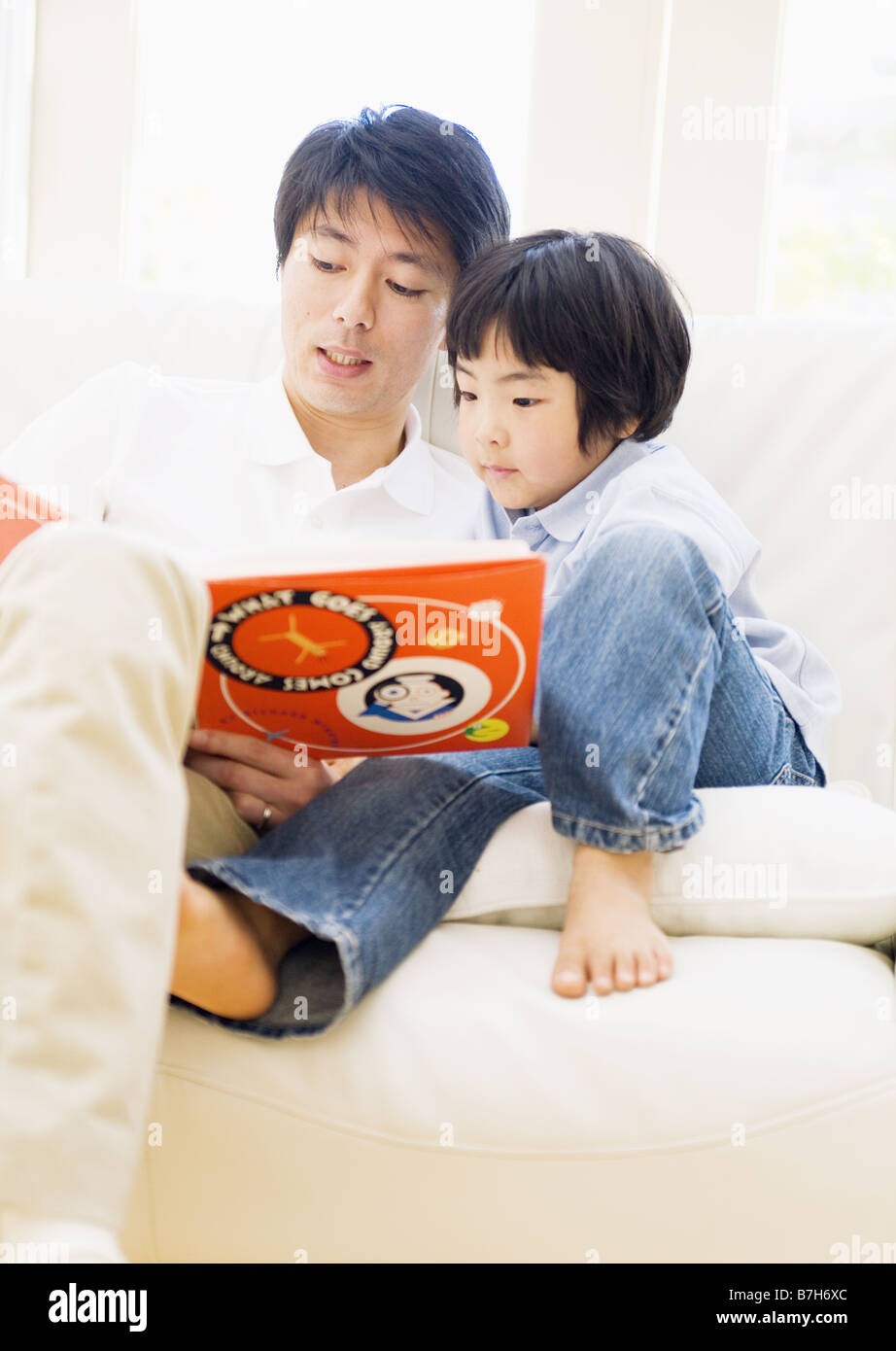Father Reading to His Son Stock Photo - Alamy