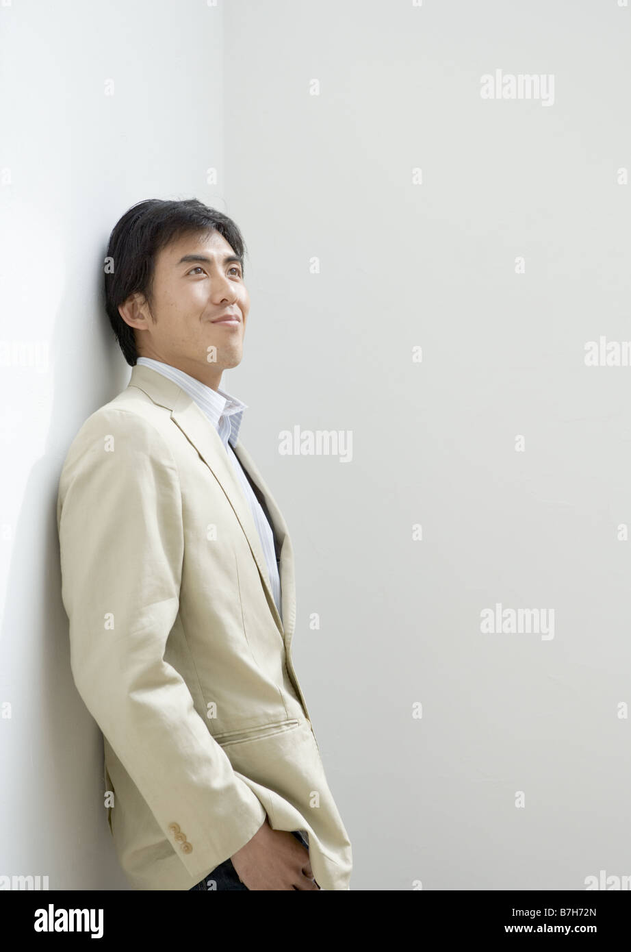 Man Leaning Against a Wall Stock Photo - Alamy