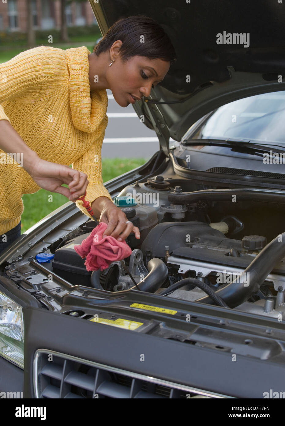 African woman checking oil in car engine Stock Photo - Alamy