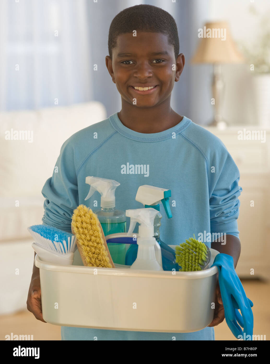African boy holding bucket of cleaning supplies Stock Photo - Alamy