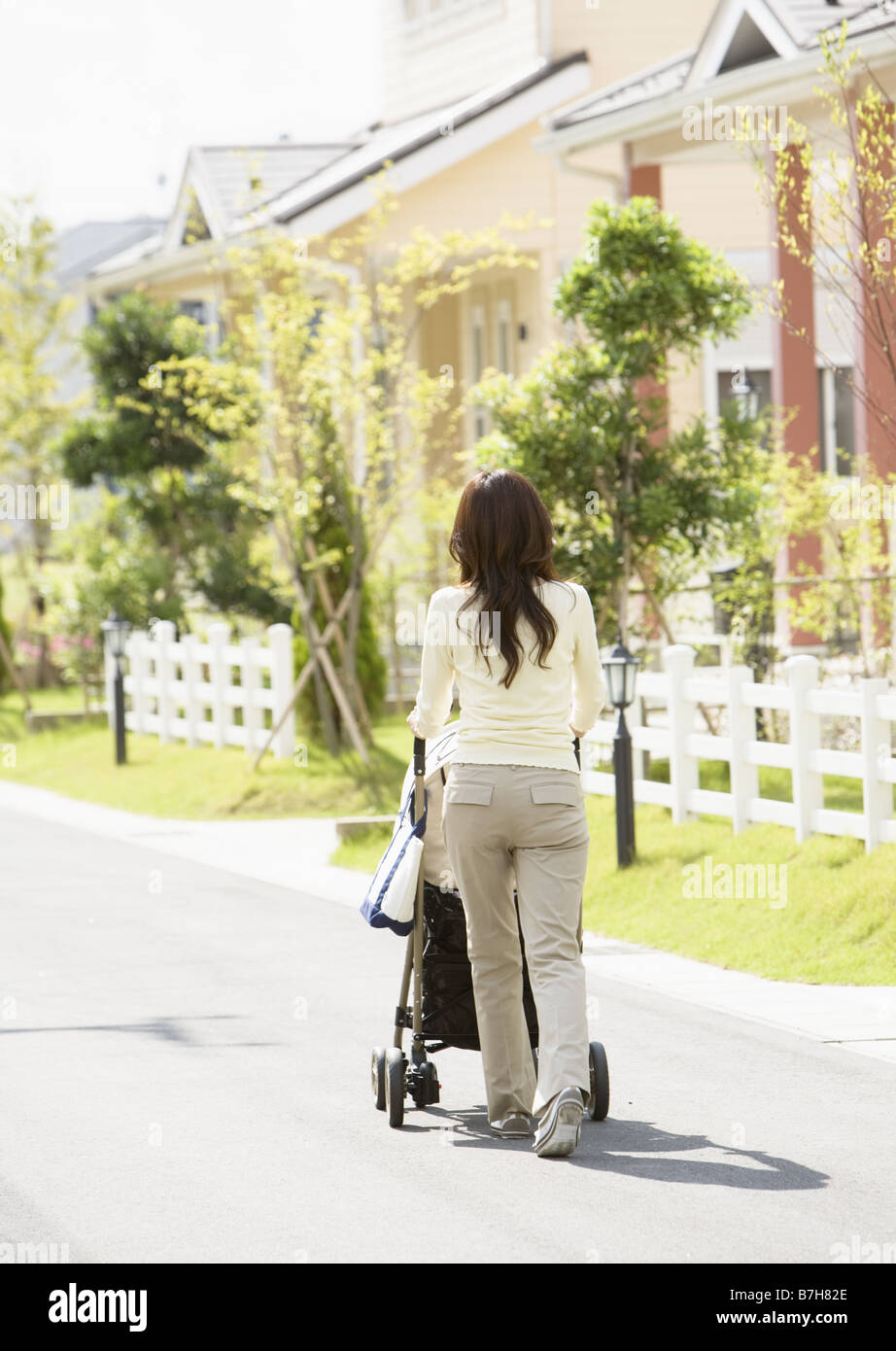 Mother pushing baby buggy Stock Photo - Alamy