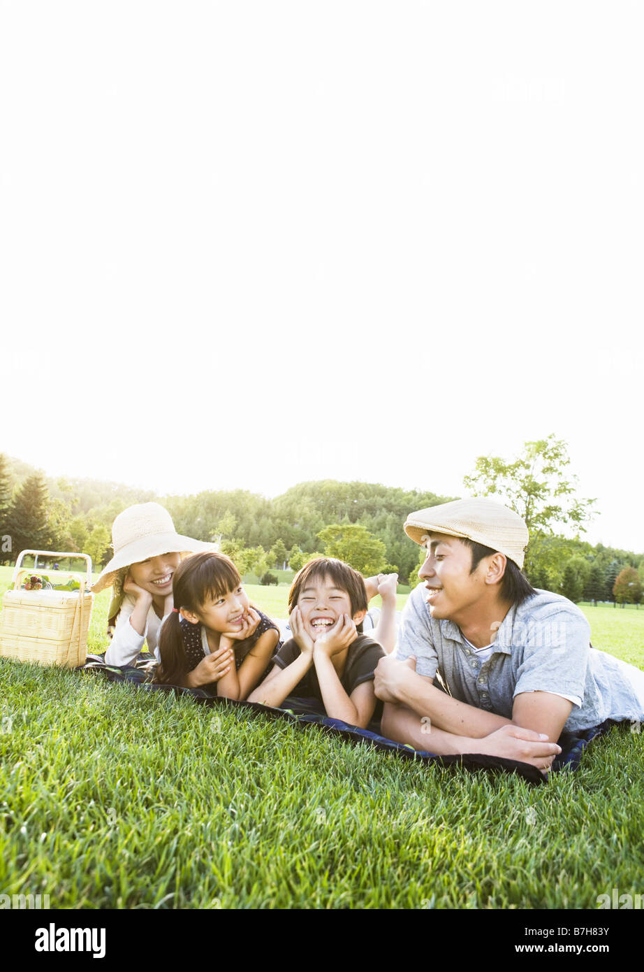 Family lying on the field Stock Photo - Alamy