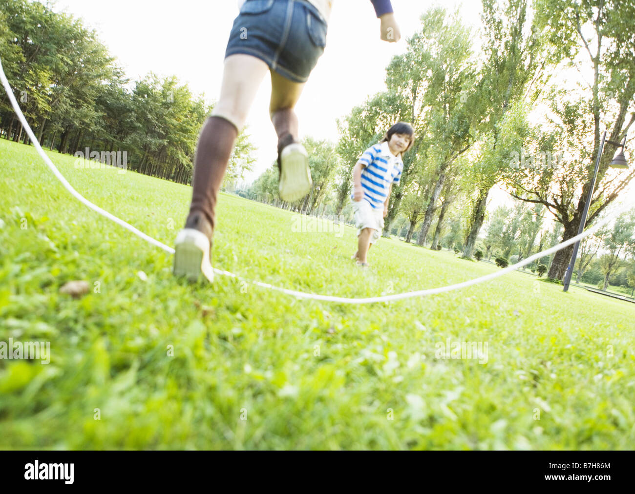 Children jumping rope Stock Photo - Alamy