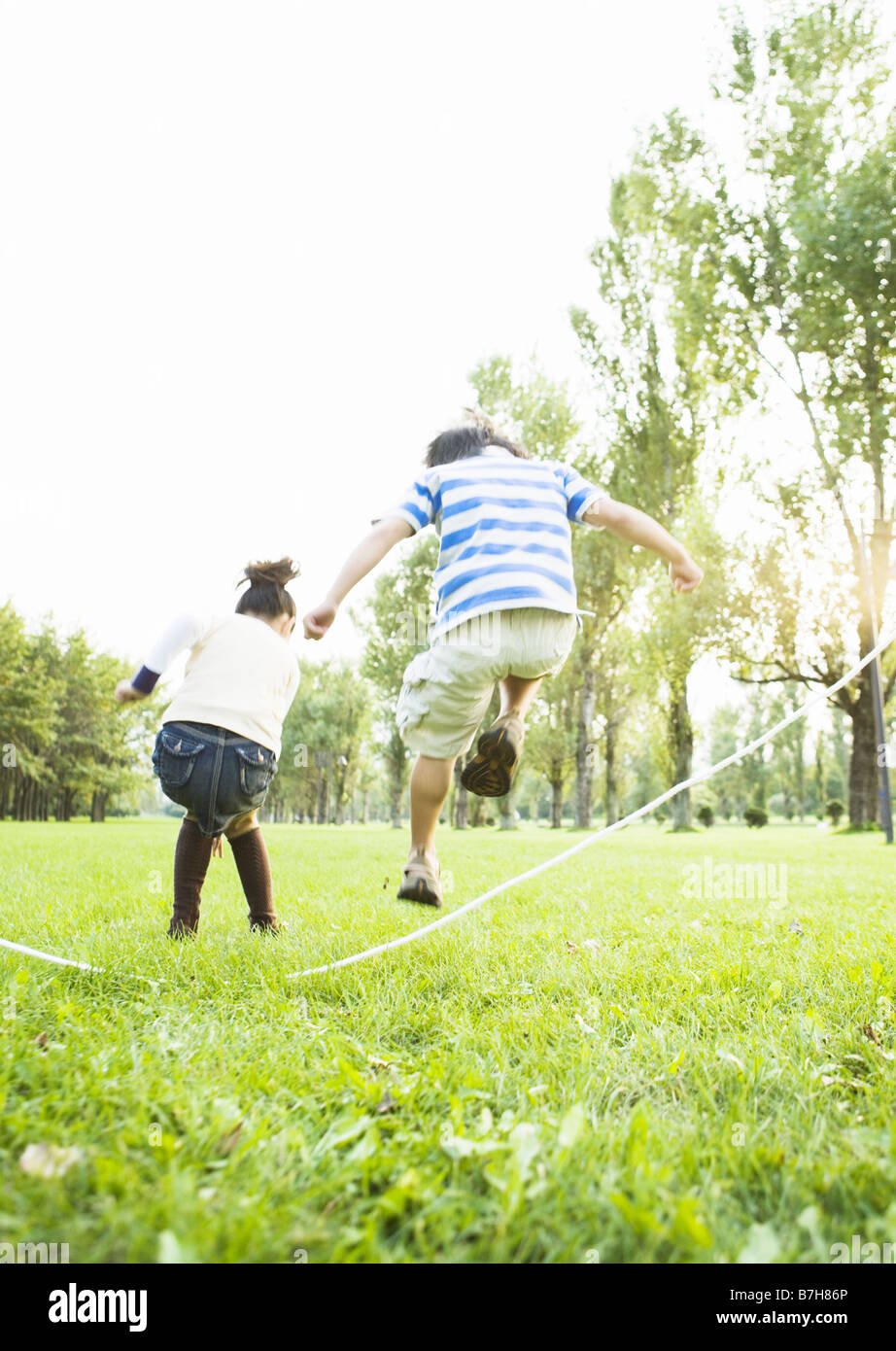 Children jumping rope Stock Photo - Alamy
