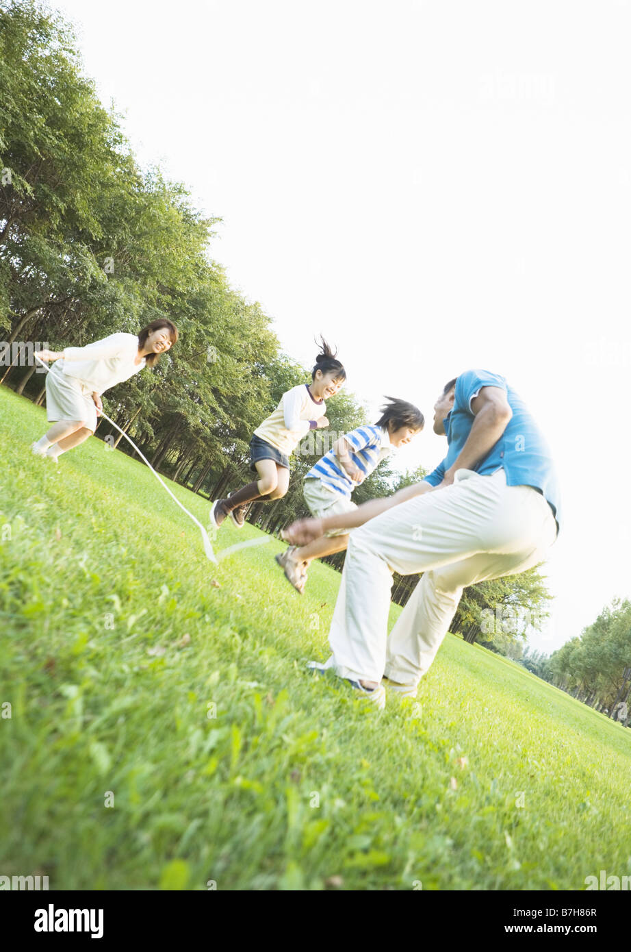 Family jumping rope Stock Photo - Alamy