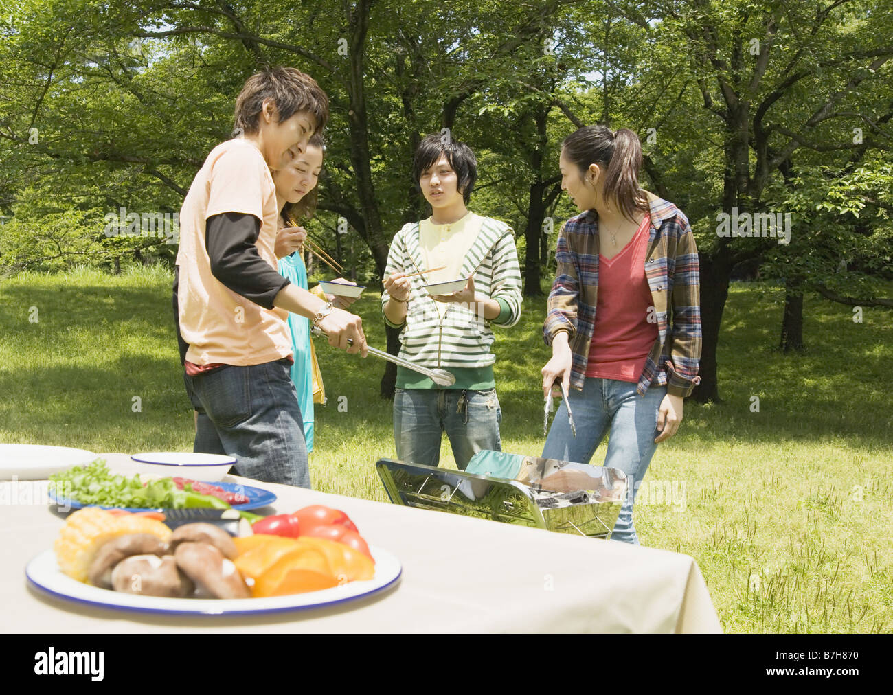 Young people barbecuing bbq hi-res stock photography and images - Alamy
