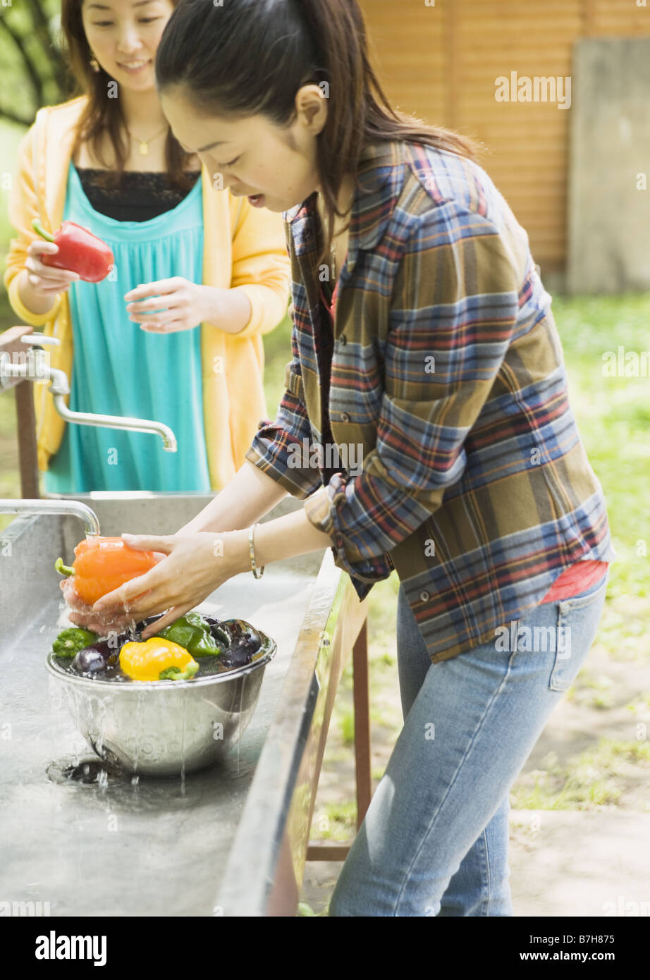 Woman washing vegetables Stock Photo - Alamy