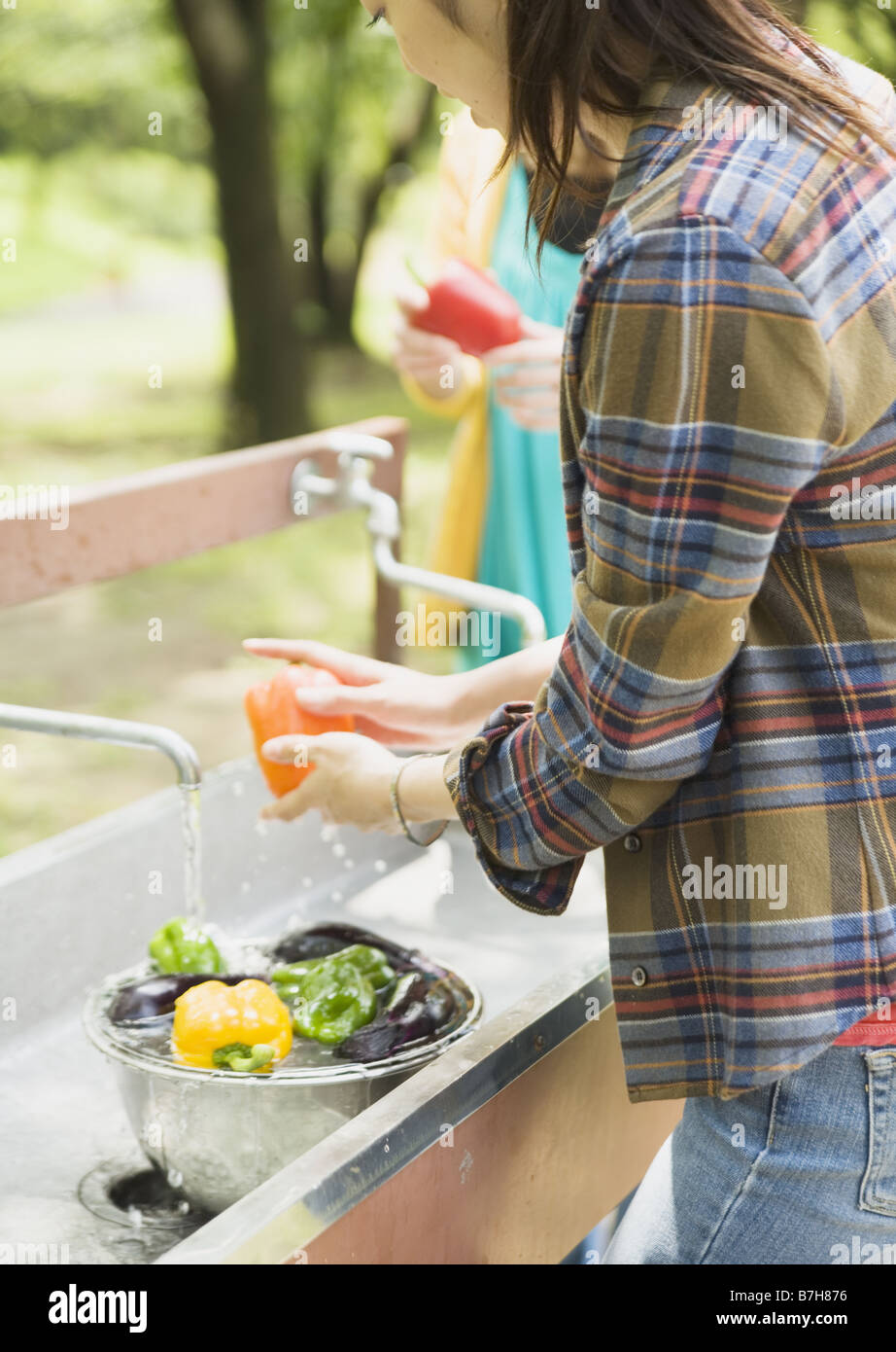 Woman washing vegetables Stock Photo - Alamy