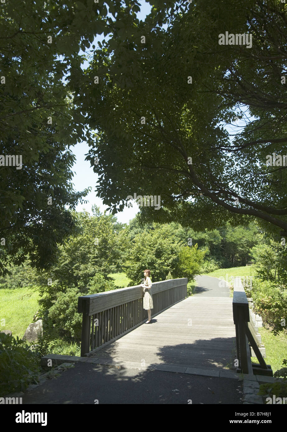 A woman standing at the bridge Stock Photo - Alamy