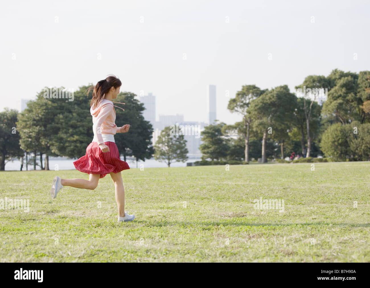A woman running in the park Stock Photo - Alamy