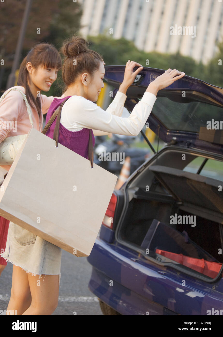 Young woman opening trunk car hi-res stock photography and images - Alamy