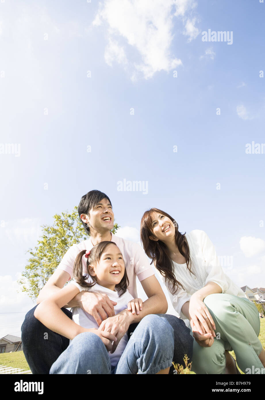 Family looking up at the sky Stock Photo - Alamy