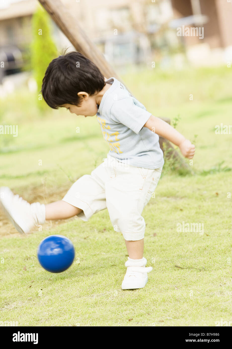 A boy playing with a ball Stock Photo - Alamy
