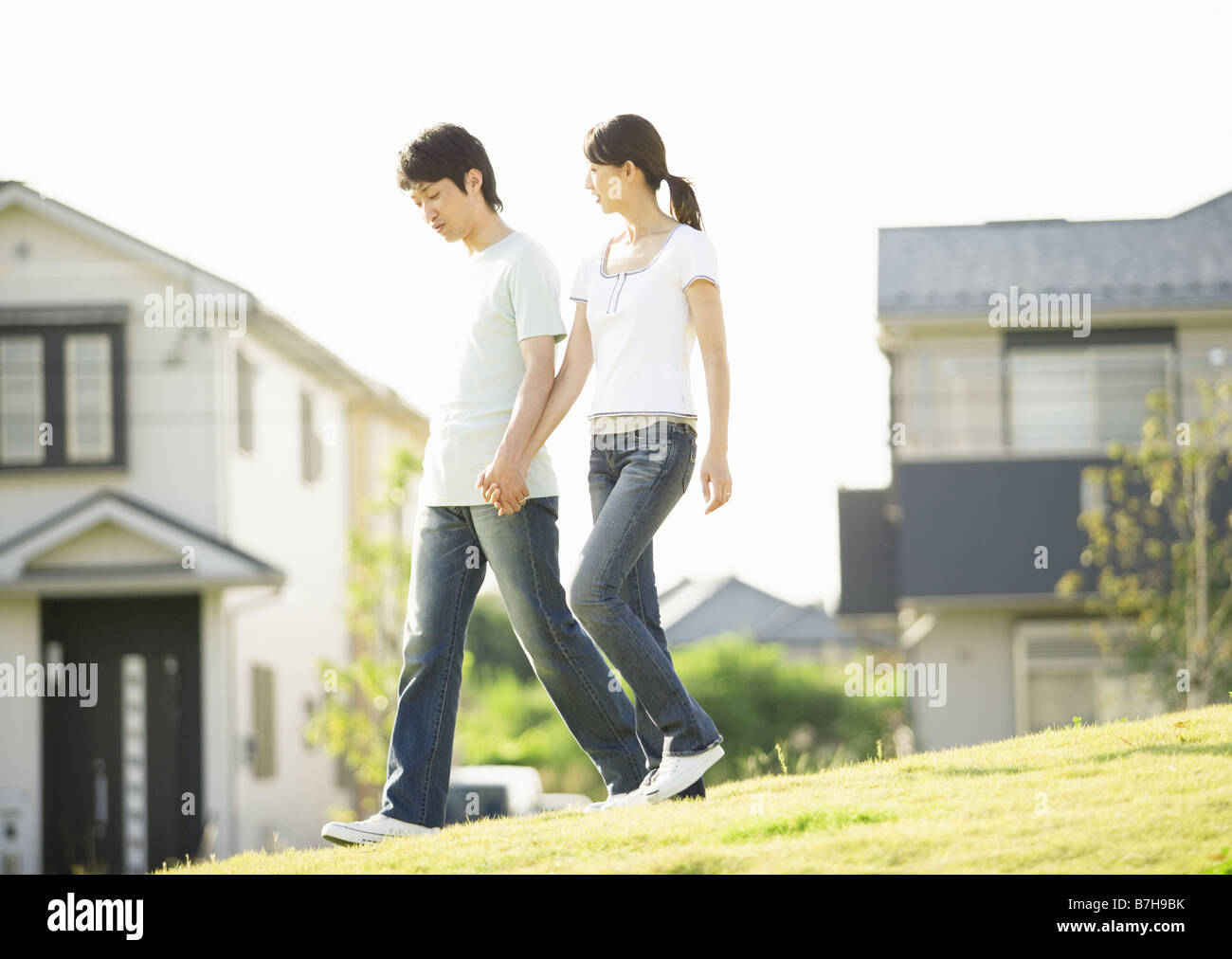Couple walking with holding hands Stock Photo - Alamy