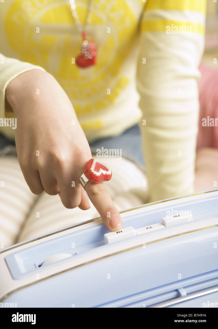A woman pushing button of the radio Stock Photo - Alamy