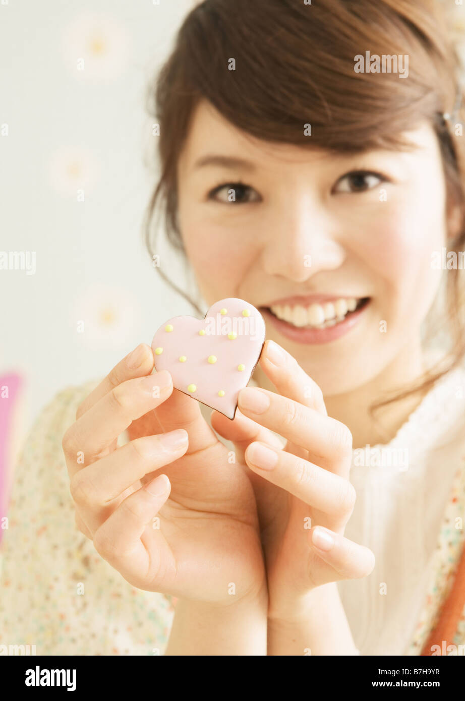 A woman holding cookie Stock Photo - Alamy