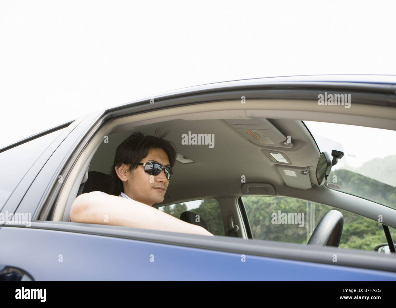 A young man driving a car Stock Photo - Alamy