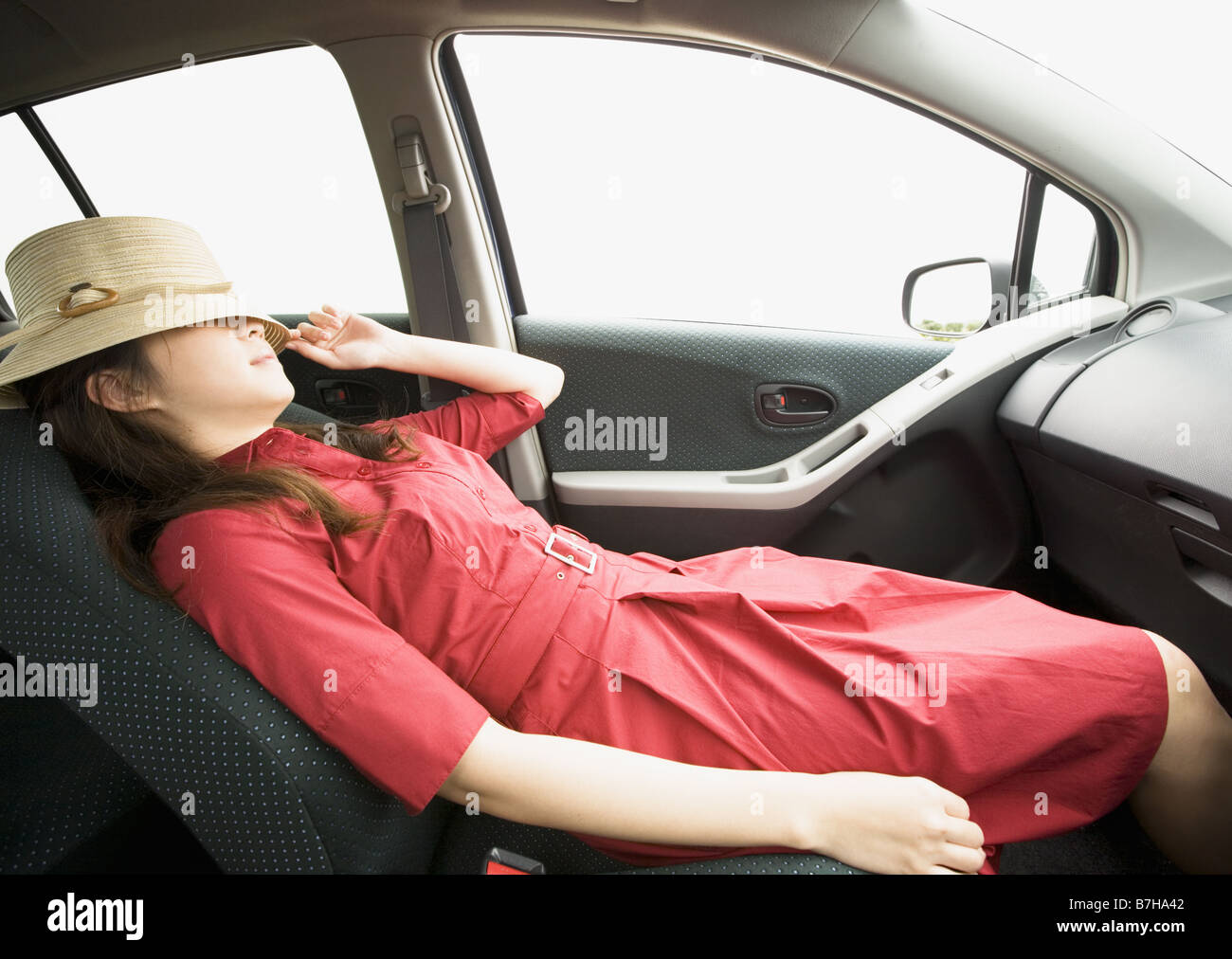 A woman taking a rest in a car Stock Photo - Alamy