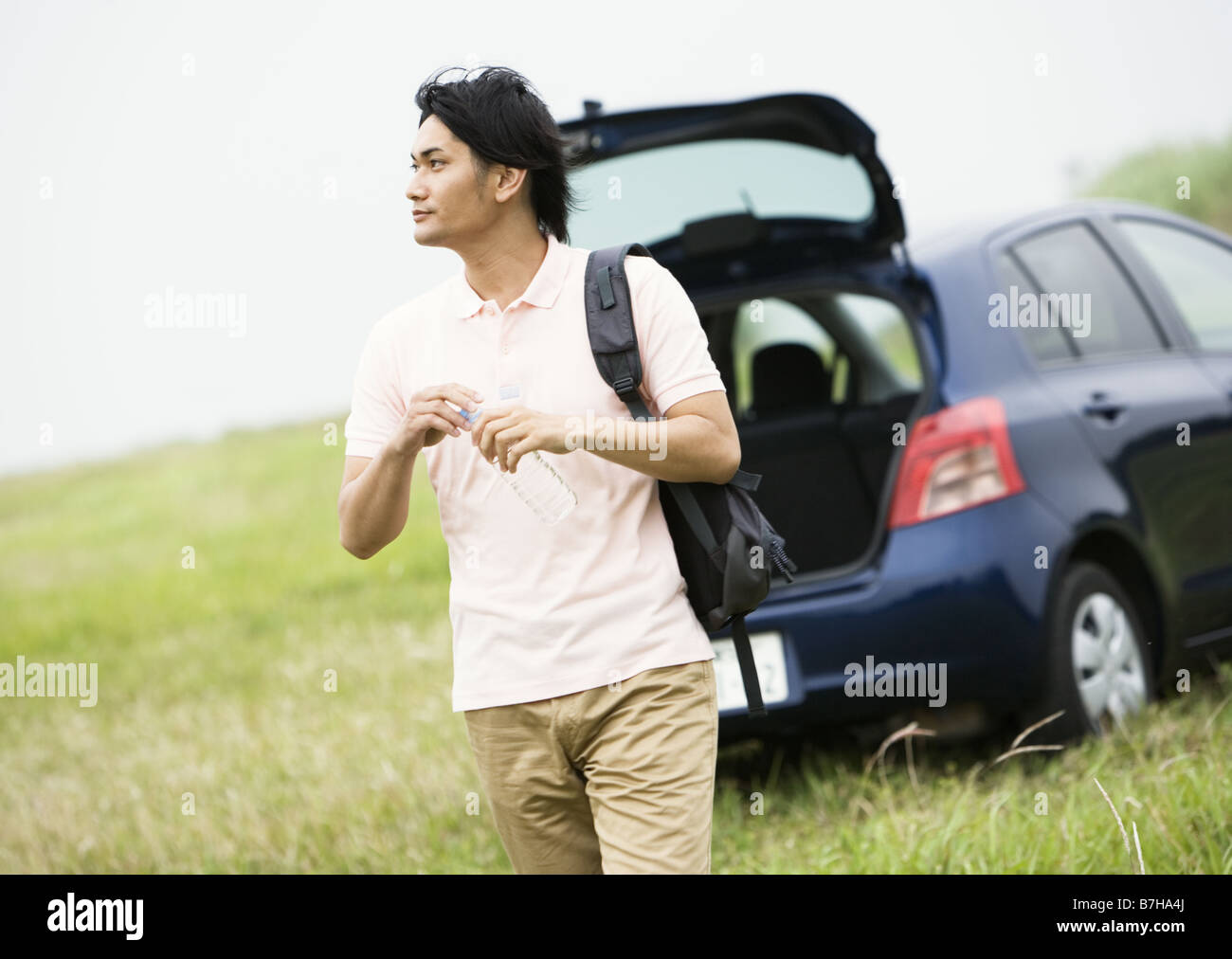 A man taking a walk in a field of grass Stock Photo - Alamy