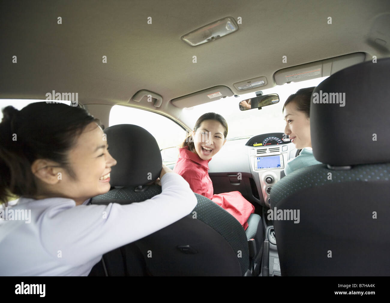 Young people having a chat in a car Stock Photo - Alamy