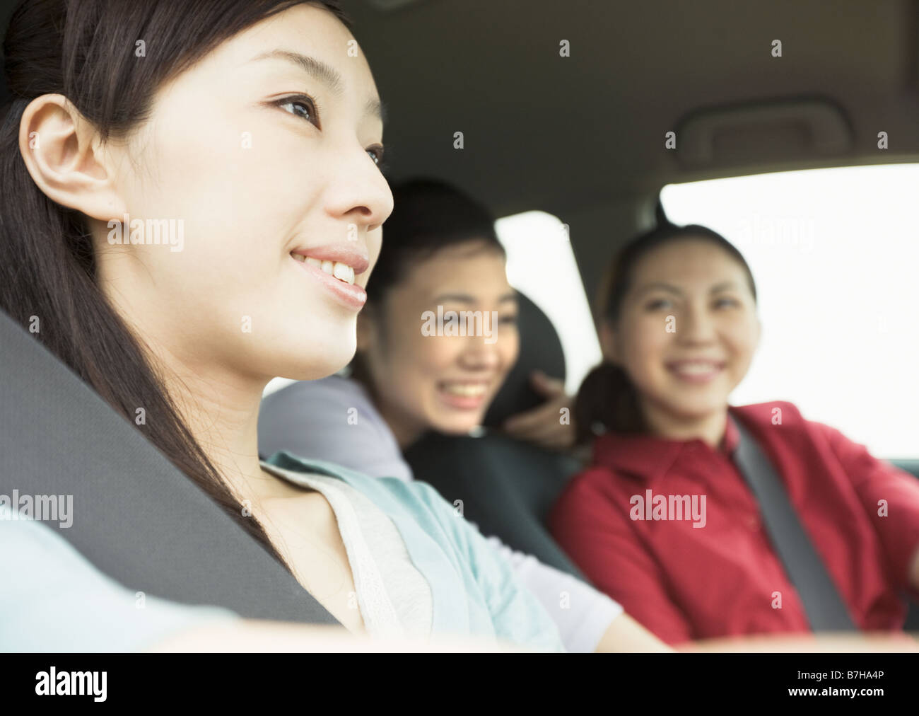 Three young women driving a car Stock Photo - Alamy