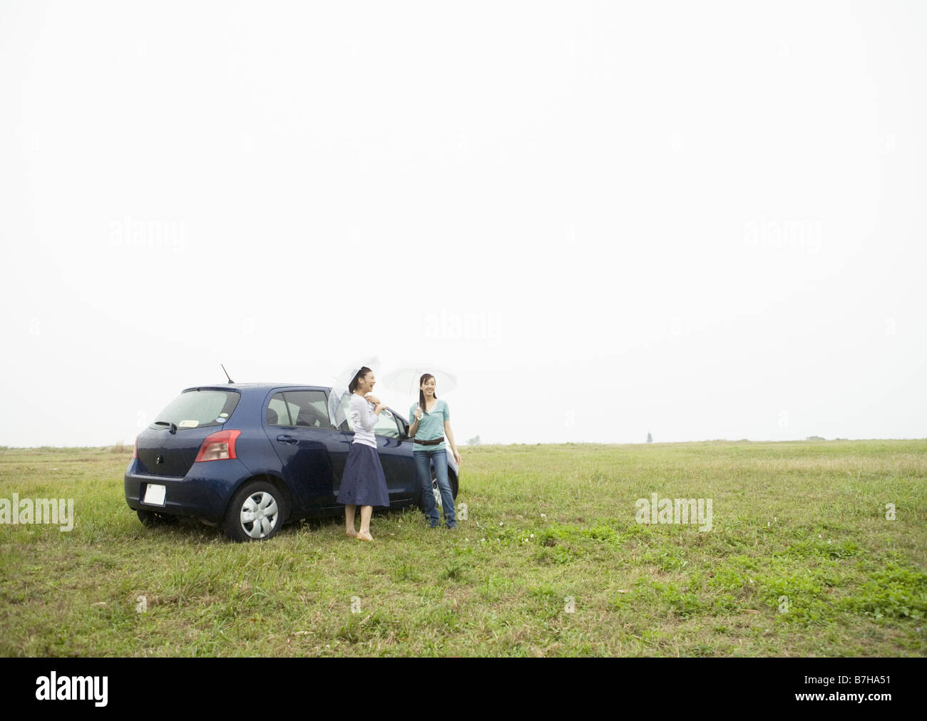 People with a car in a field Stock Photo - Alamy