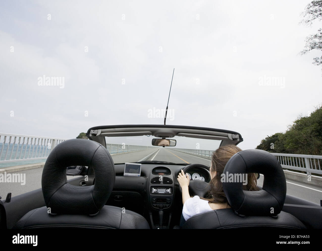 A young woman driving convertible Stock Photo - Alamy