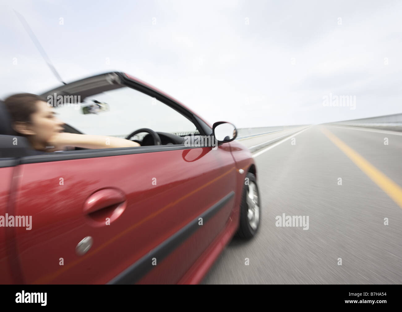 A young woman driving convertible Stock Photo - Alamy