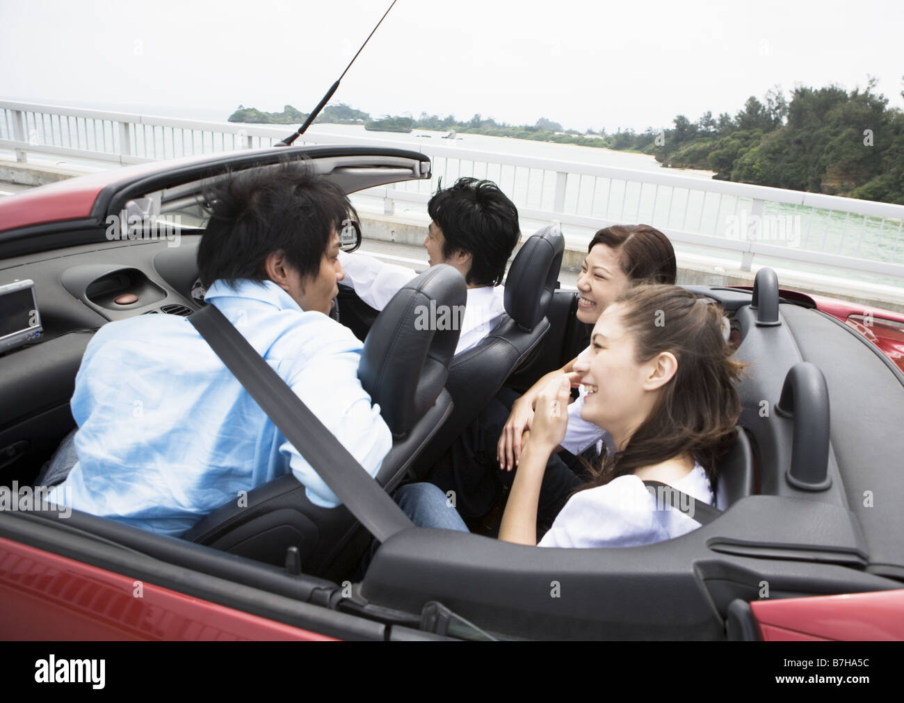 Young people driving a convertible Stock Photo - Alamy