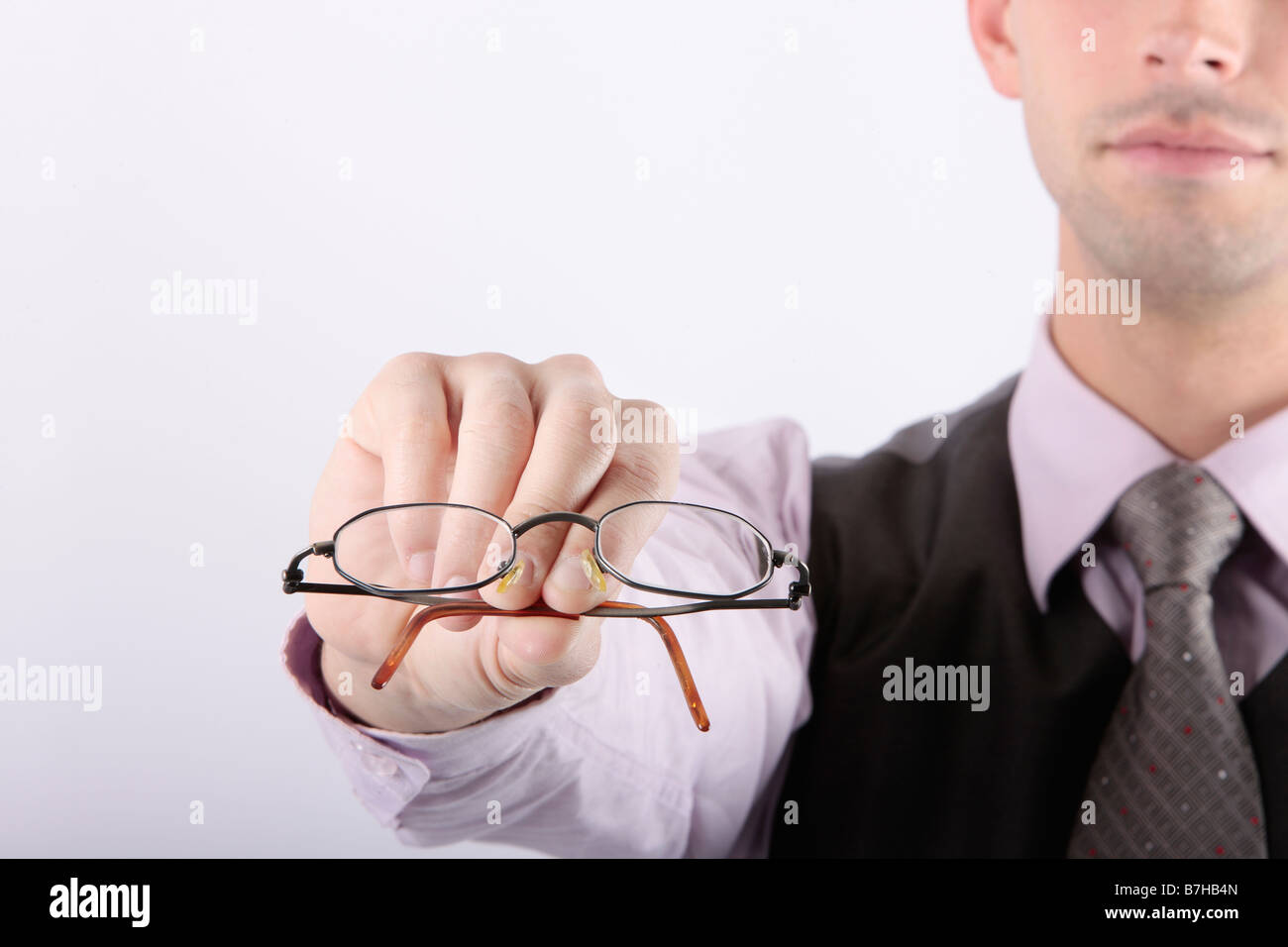 close-up of reading glasses in man's hand Stock Photo - Alamy