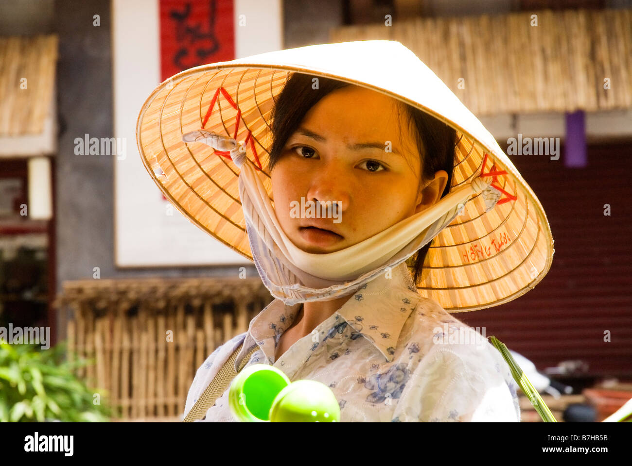 Lady wearing traditional SE Asia cone hat. Ho Chi Minh Stock Photo - Alamy