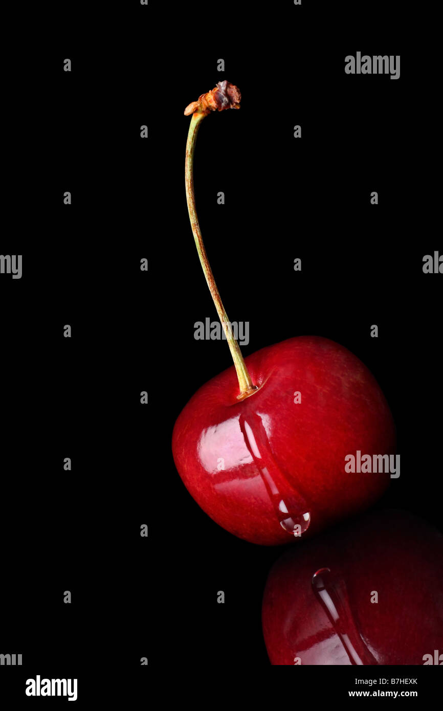 lovely ripe red cherry on a reflective surface Stock Photo - Alamy