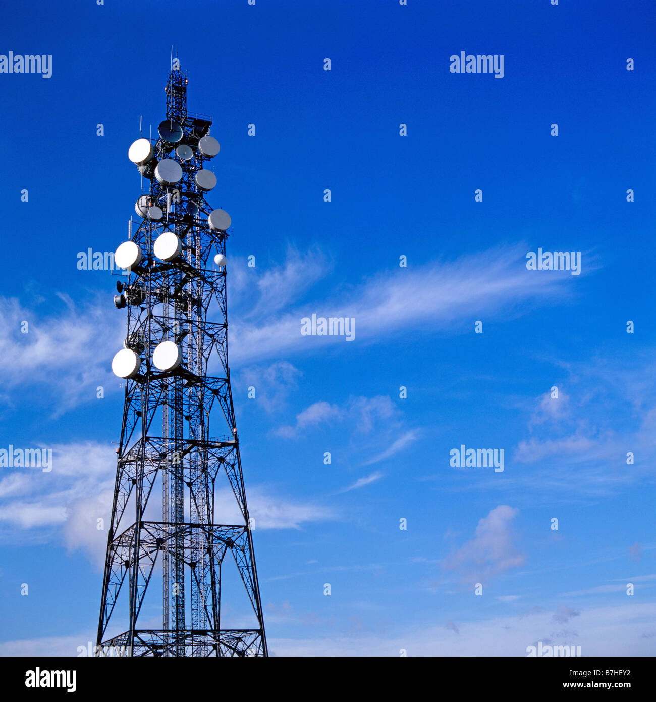 Telecommunication mast with blue sky background Stock Photo - Alamy