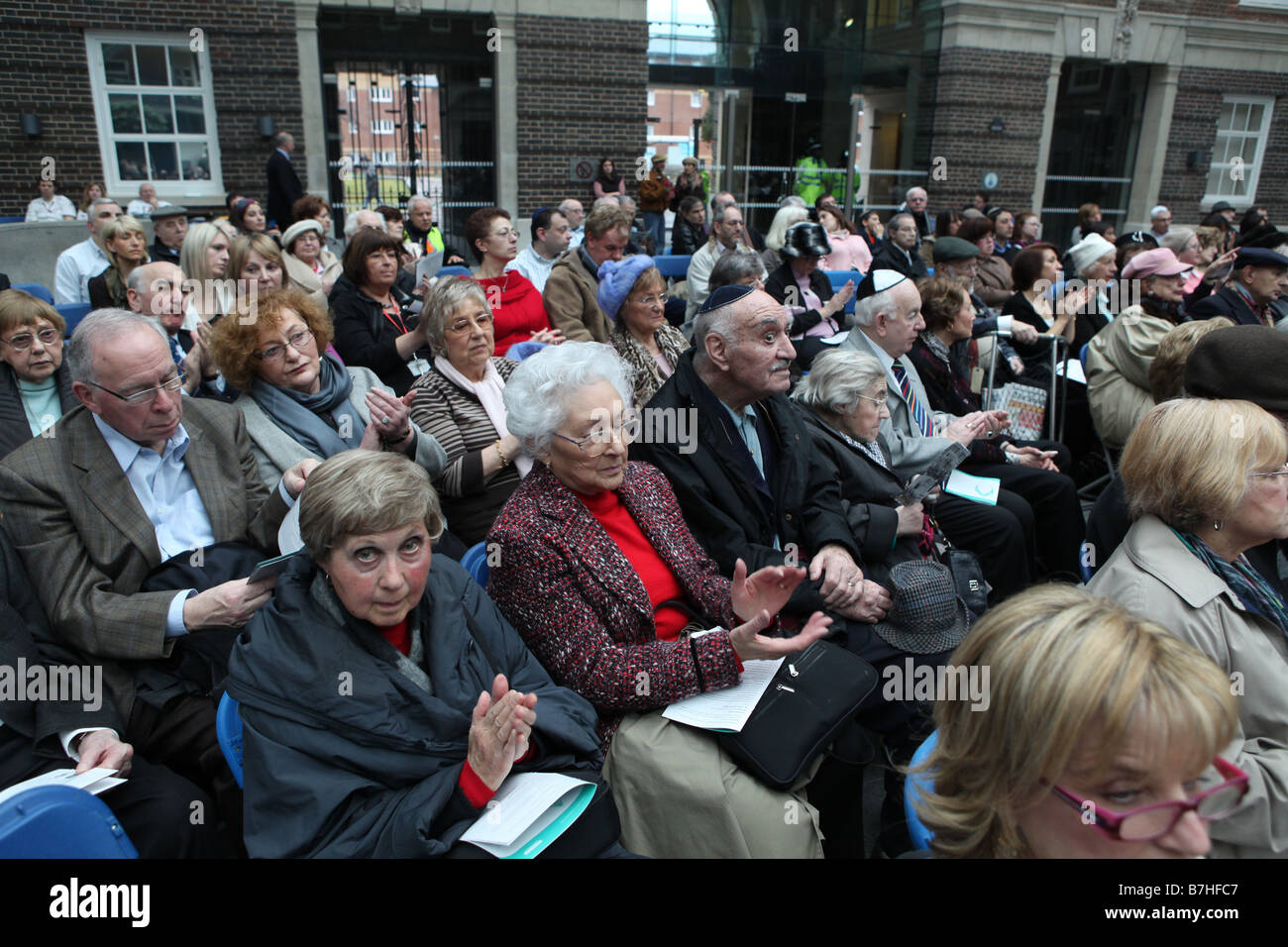 crowds and holocaust survivors watching speeches during the holocaust ...