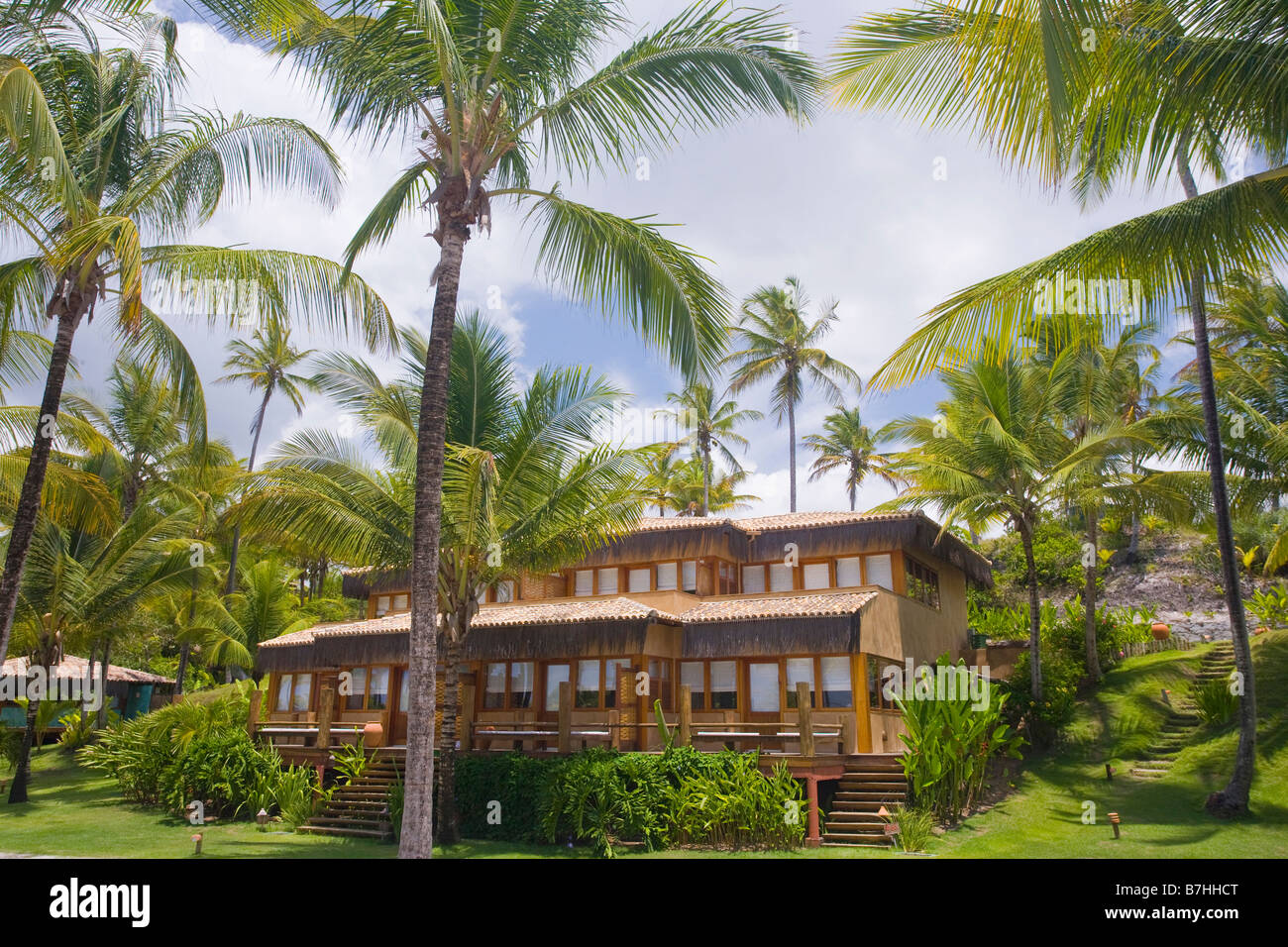 Rustic beach house with wooden veranda among palm trees in Brazil Stock ...
