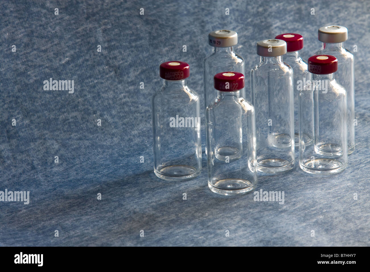 Group of various sized medical vials on blue background Stock Photo - Alamy