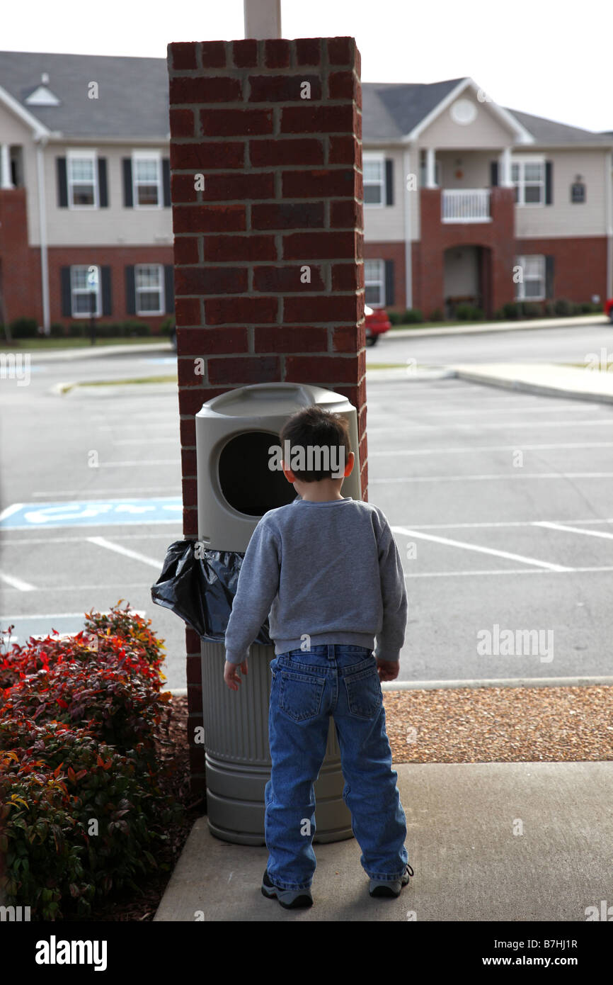 Five year old boy looking at garbage can Stock Photo - Alamy