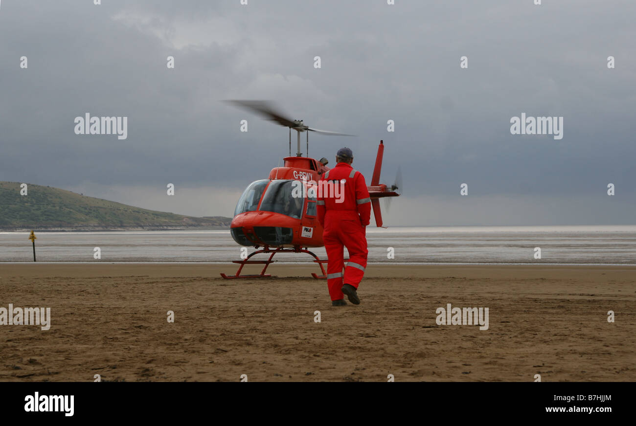 Red Helicopter landing Stock Photo - Alamy
