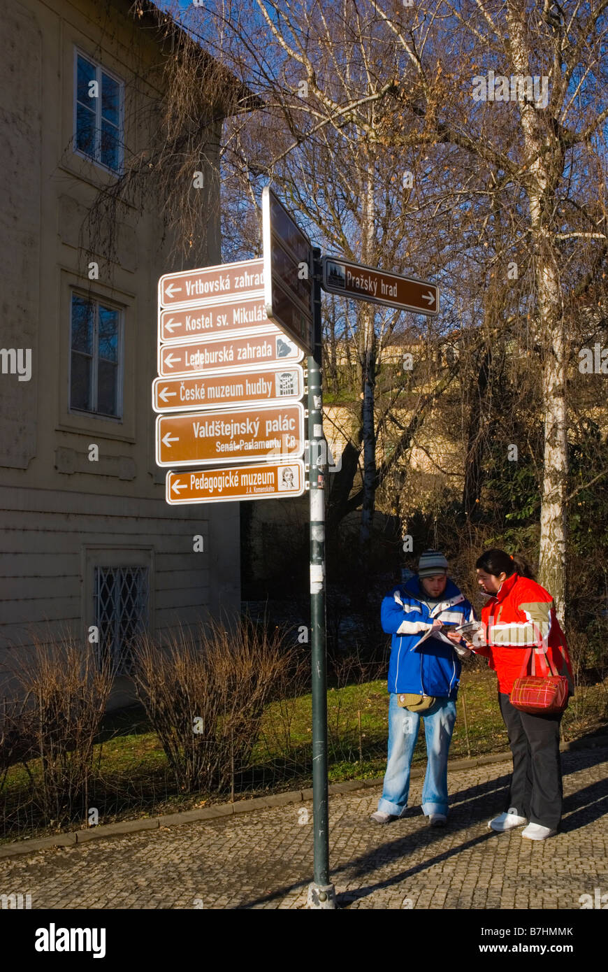 Tourists studying maps and guidebooks in Mala Strana district of Prague ...