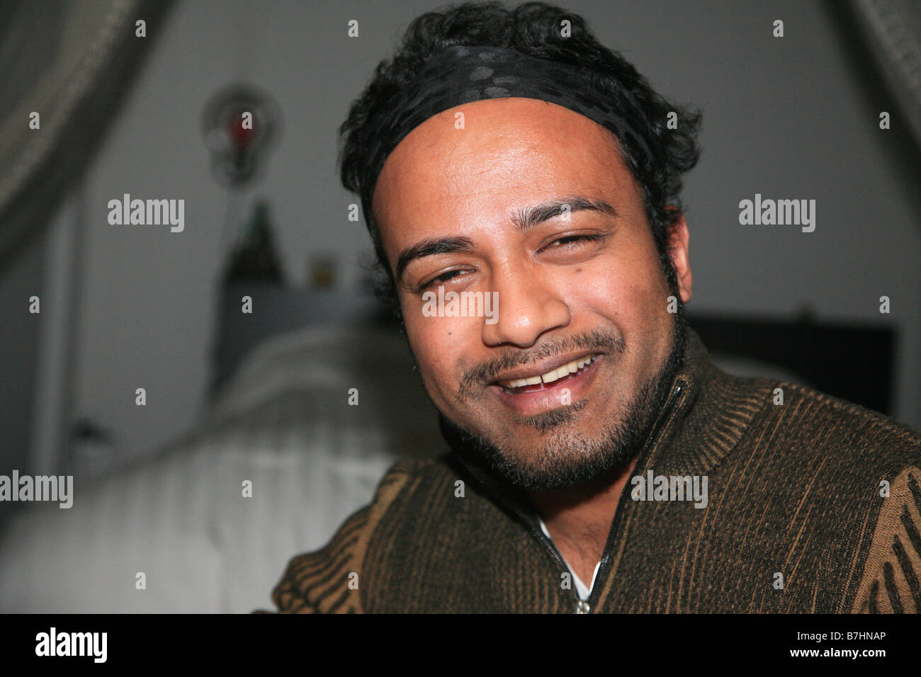 Portrait of a good looking Indian boy laughing, UK 2009 Stock Photo - Alamy