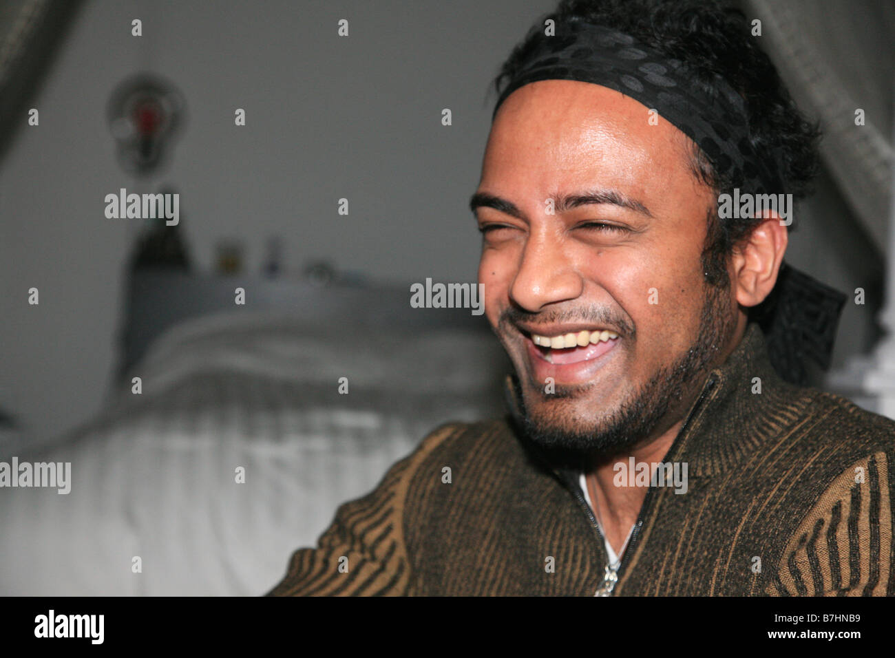 Portrait of a good looking Indian boy laughing, UK 2009 Stock Photo - Alamy