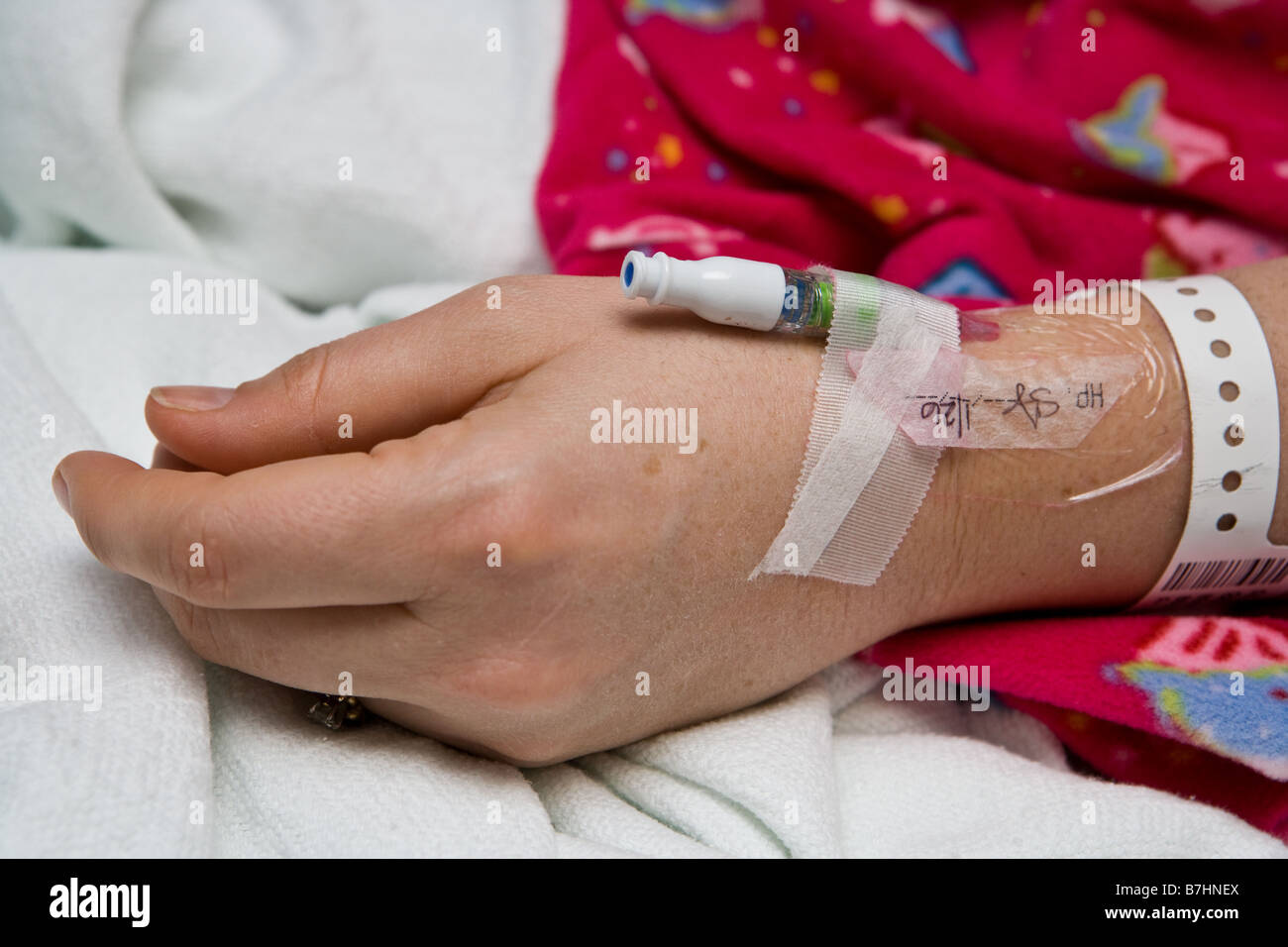 An IV in a womans hand Stock Photo - Alamy