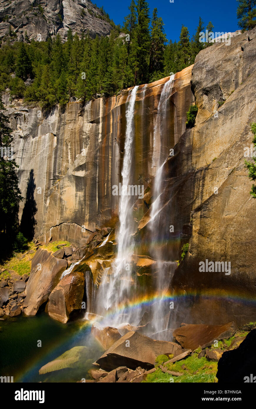 Water crashing down behind a rainbow Stock Photo - Alamy