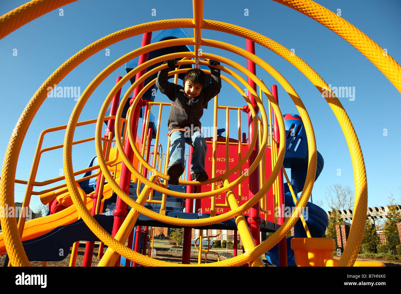 Adorable five year old boy playing at park in cold weather Stock Photo ...